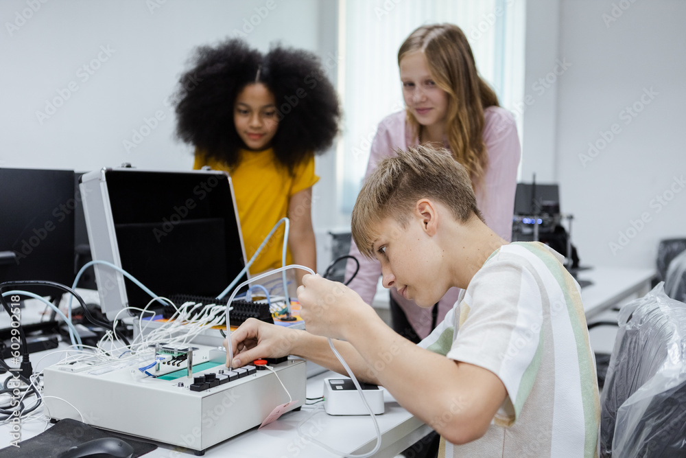 Boy learning to repair electrical appliances. education on table at ...
