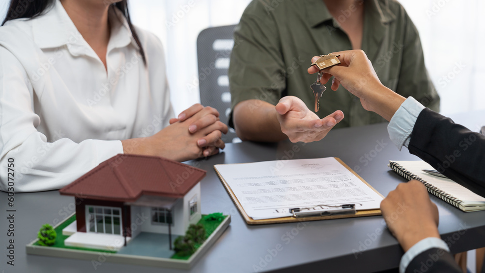 Real estate agent hand over house key to buyer after successful payment ...
