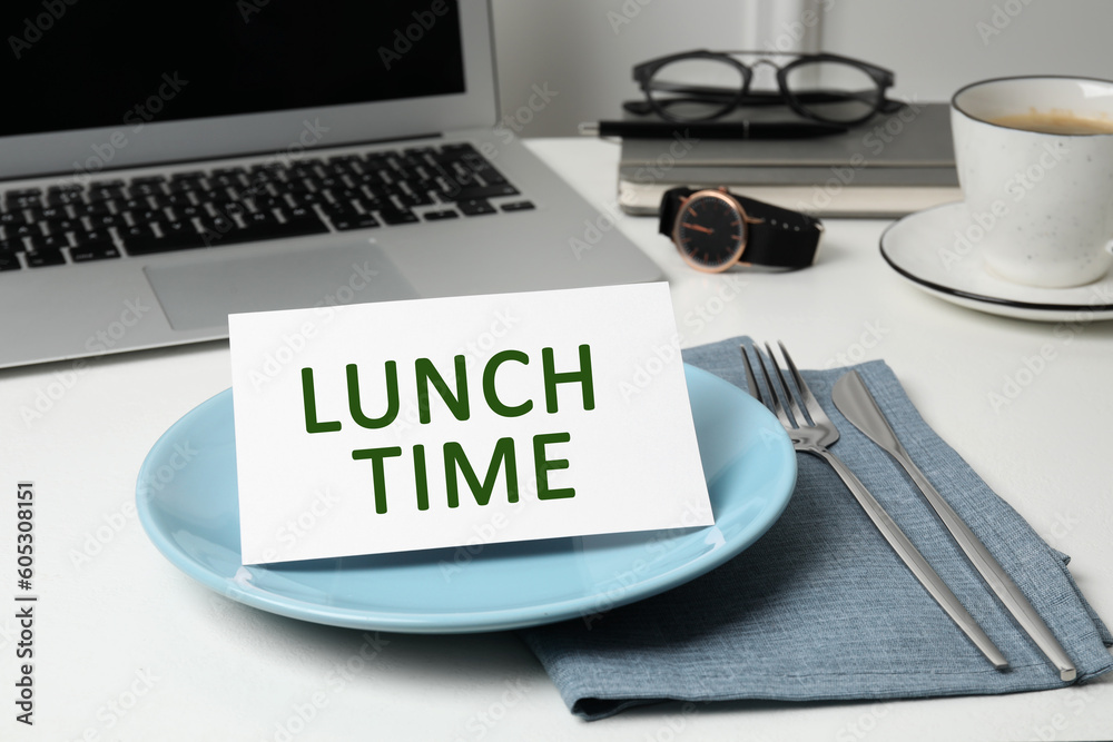 Business lunch. Office desk with plate, cutlery and laptop. Card with ...