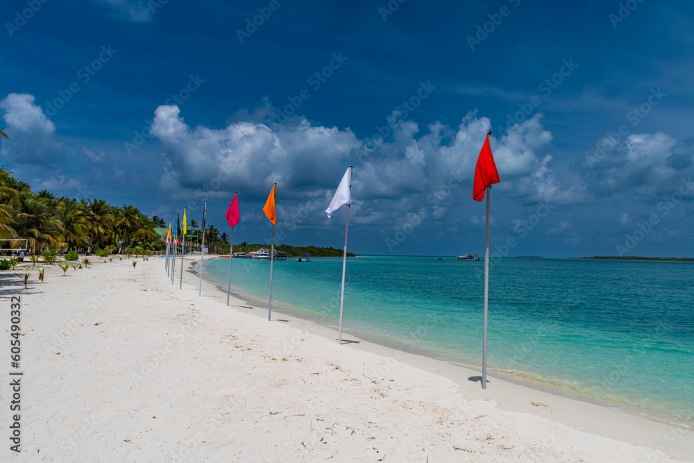 White sand beach with many flags, Bangaram island, Lakshadweep ...