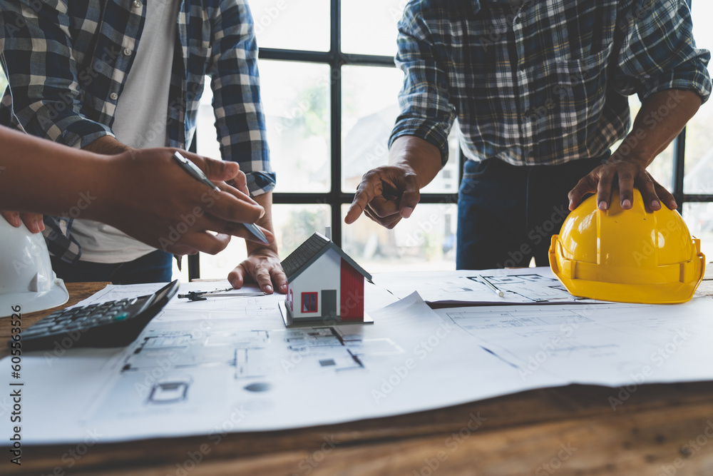 Foto Team of engineers, architects meeting plans on blue print house ...