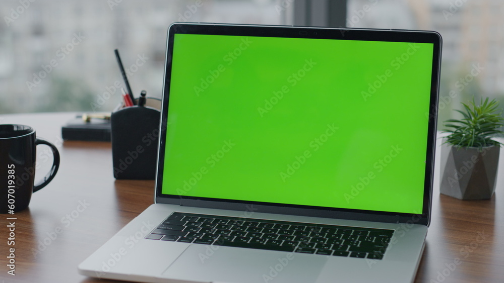 Modern green screen laptop standing on office desk close up. Chroma key ...