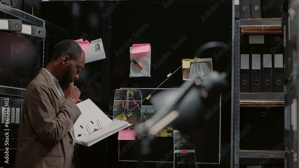 Private detective looking at evidence on board and comparing police ...