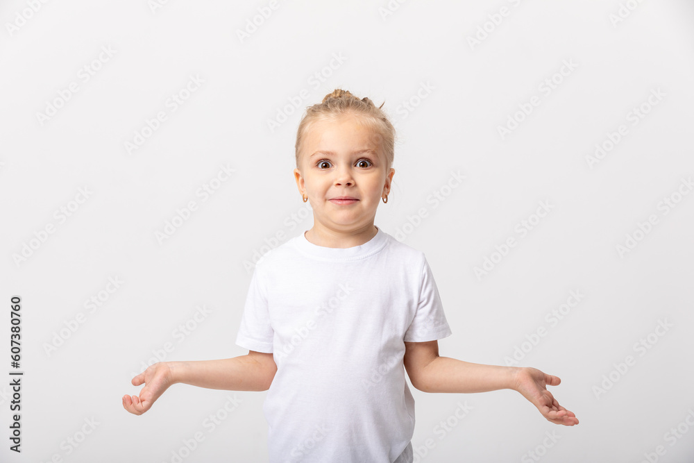 Confused doubtful shocked little girl shrugging feel baffled looking at ...