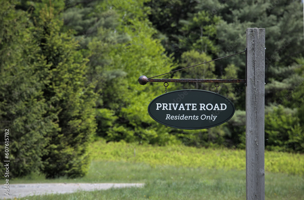 private road (residents only) sign on wooden signpost with road and ...