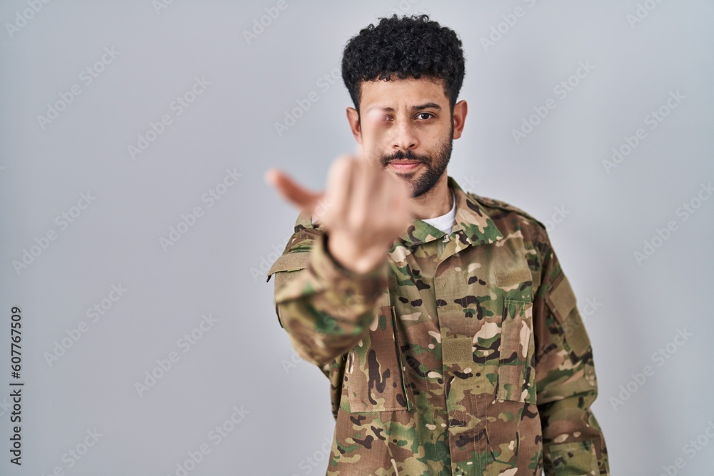 Arab man wearing camouflage army uniform showing middle finger ...