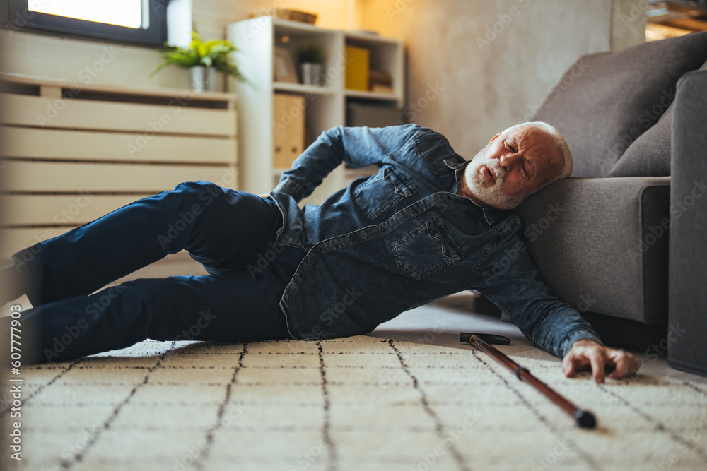 Senior man falling on the ground with walker in living room at home ...