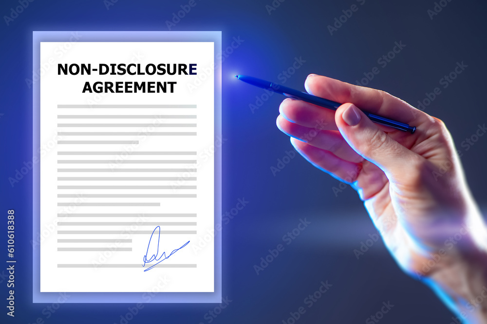 Non-disclosure agreement. Hand near NDA contract. Trade secret ...