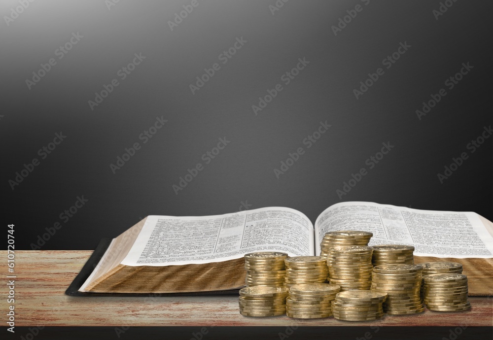 Holy Bible book and stack of coins Stock Photo | Adobe Stock