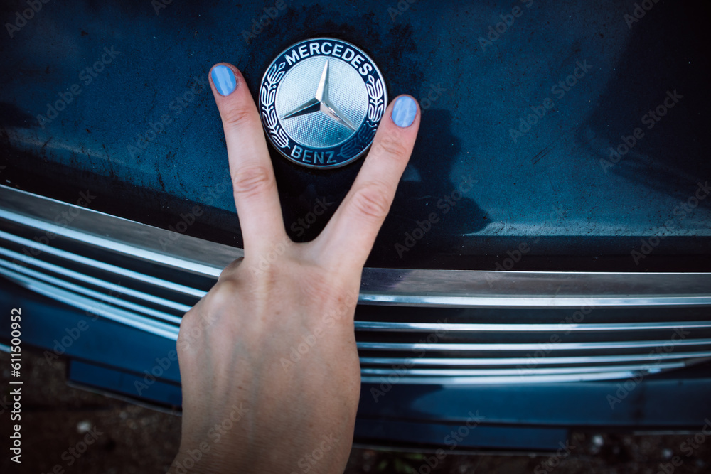 Madrid, Spain. May 1, 2023 A hood of a dark blue Mercedes Benz car logo ...