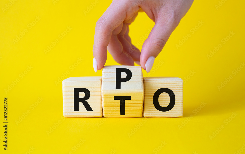 RPO vs RTO symbol. Businessman hand turns wooden cubes and changes the ...
