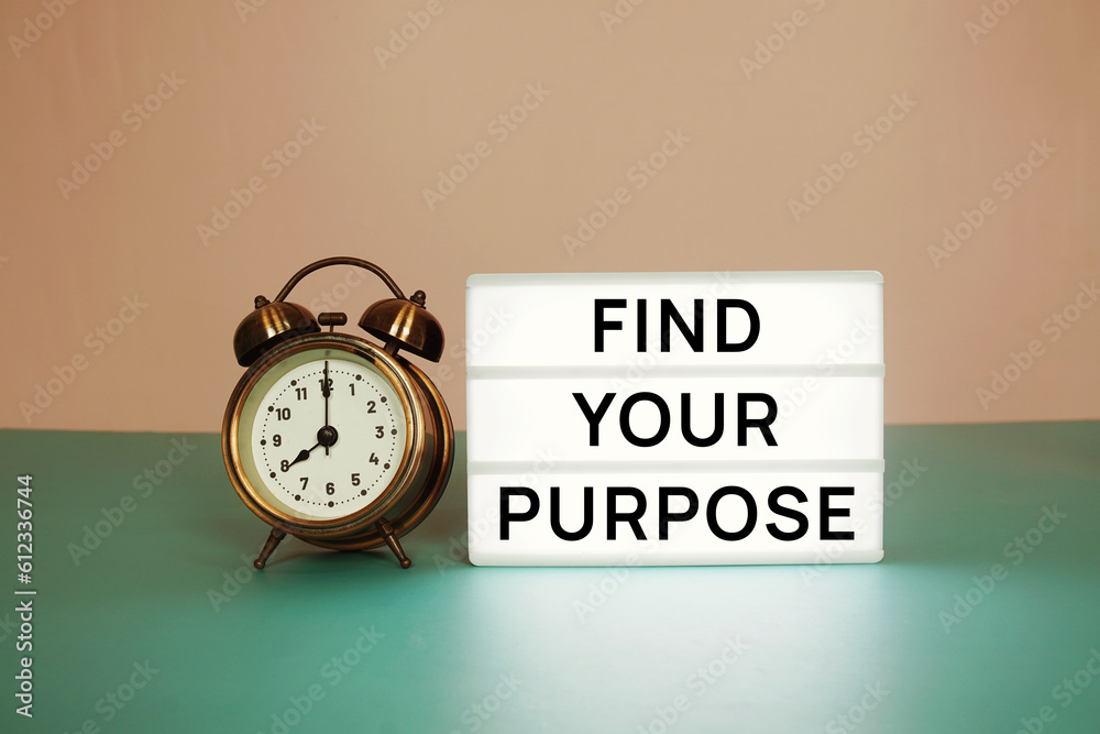 Find Your Purpose text message on paper card with wooden easel and ...
