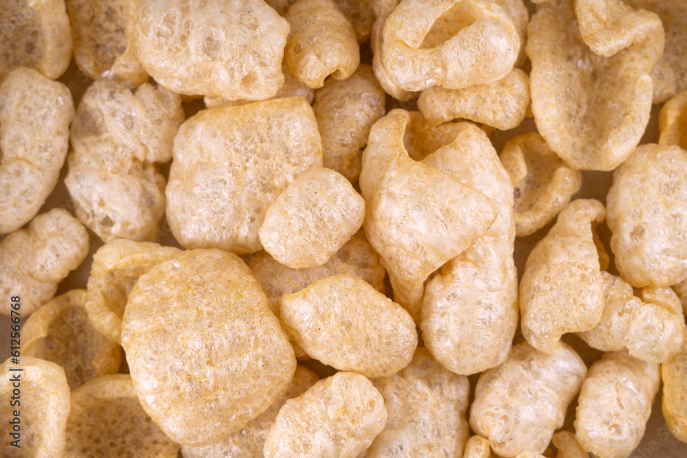 Delicious pile of fried pork cracklings or chicharron top view. Typical ...
