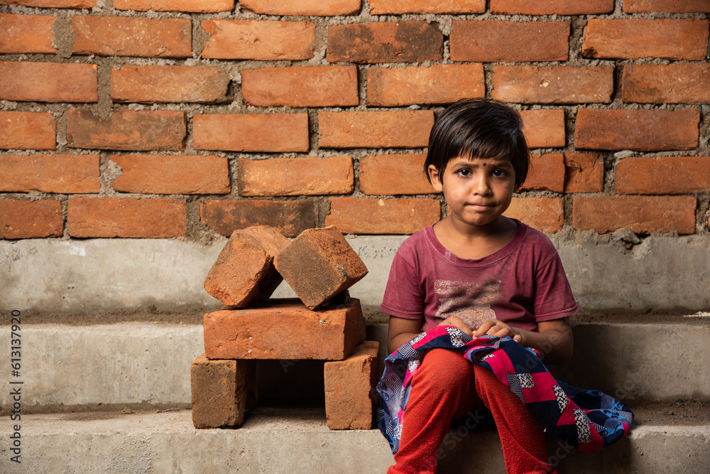 Indian asian Labour girl child posing besides conceptual brick house at ...
