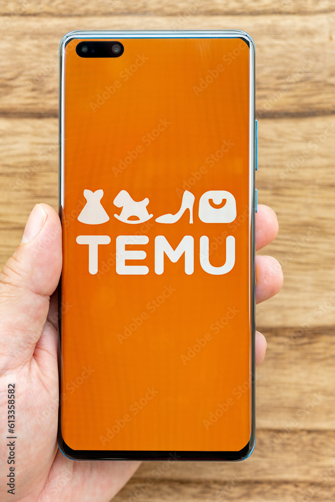 ZHONGSHAN China-June 15,2023:man holding a mobile with Temu logo at ...