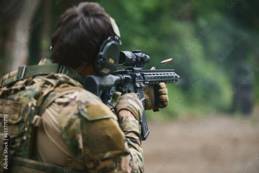 Ukrainian soldier shooting on sight with a modern American assault rifle equipped with optical ...
