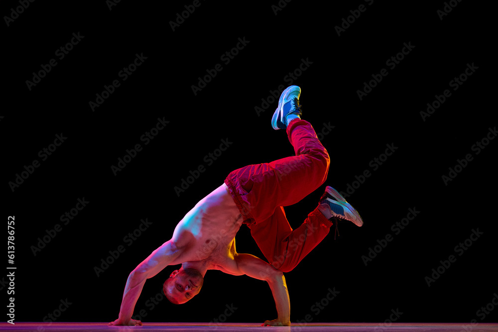 Dance show. Muscular, athletic, shirtless young man dancing breakdance ...
