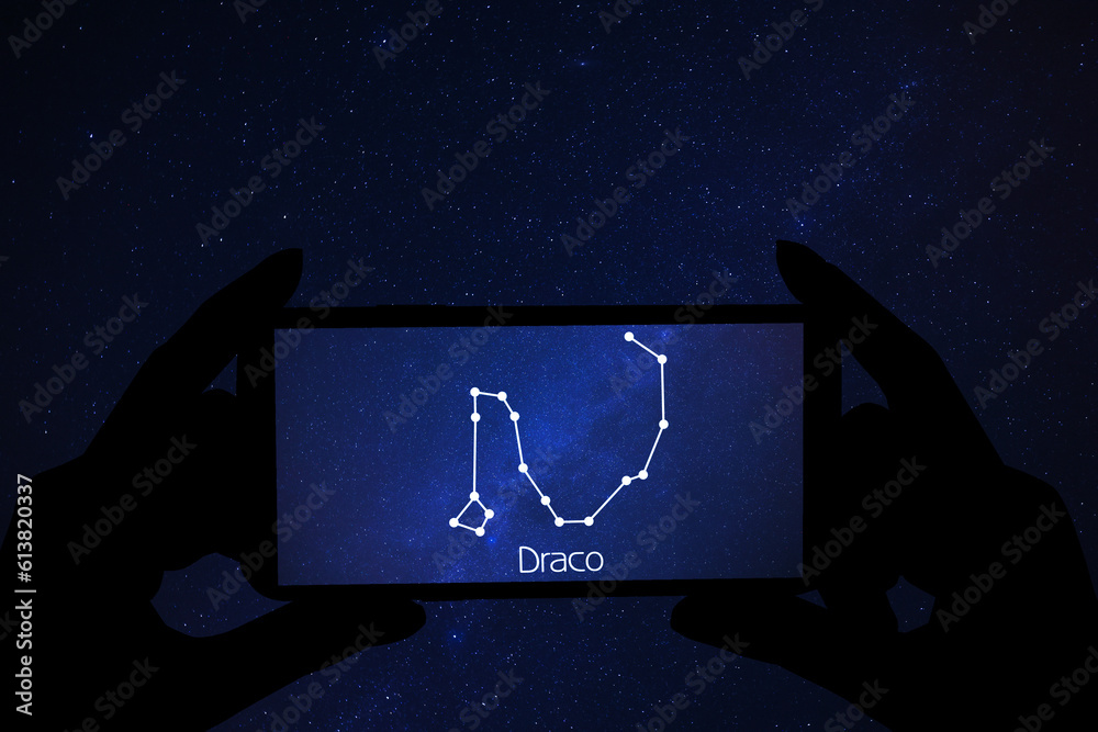 Woman using stargazing app on her phone at night, closeup. Identified ...