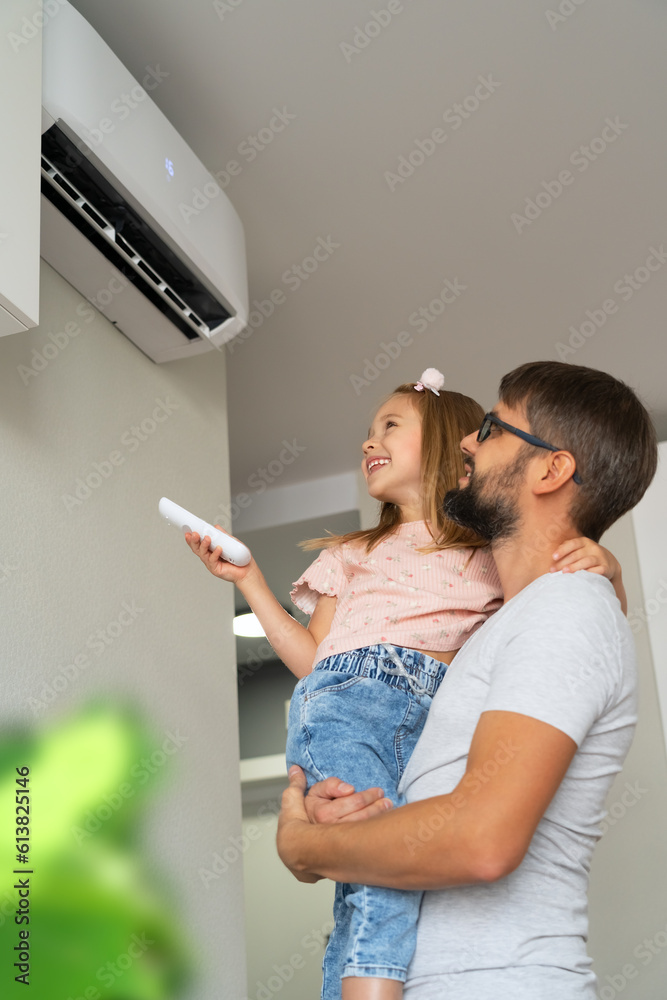 Happy family, father and little girl fun turn on air conditioner using ...