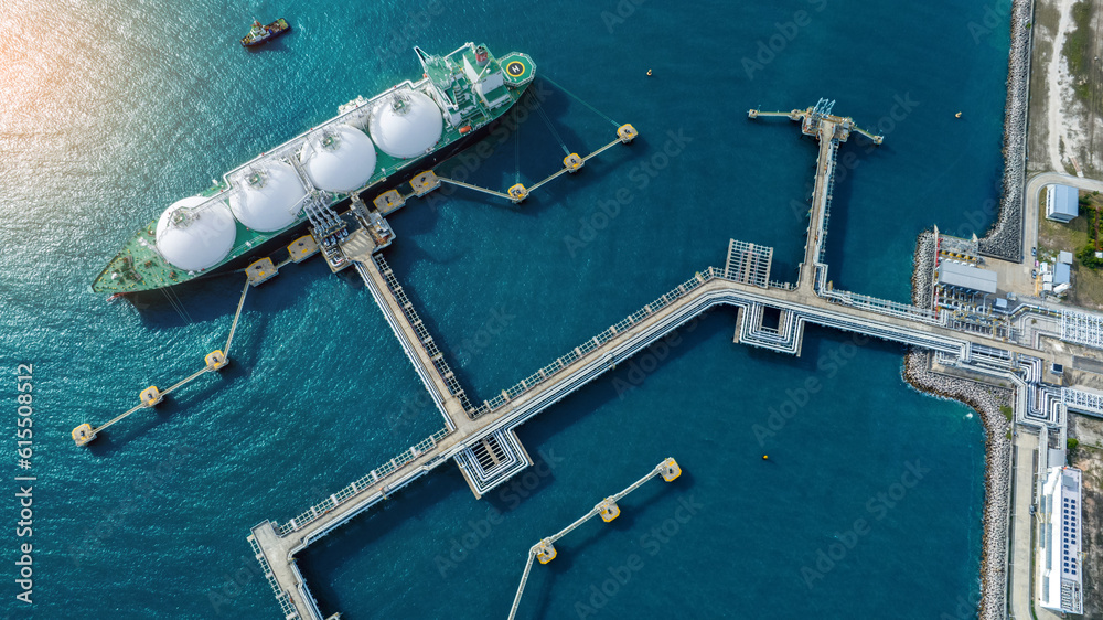 LNG (Liquified Natural Gas) tanker anchored in Gas terminal gas tanks ...