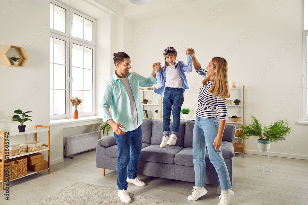 Happy smiling family having fun with their child son in the living room ...