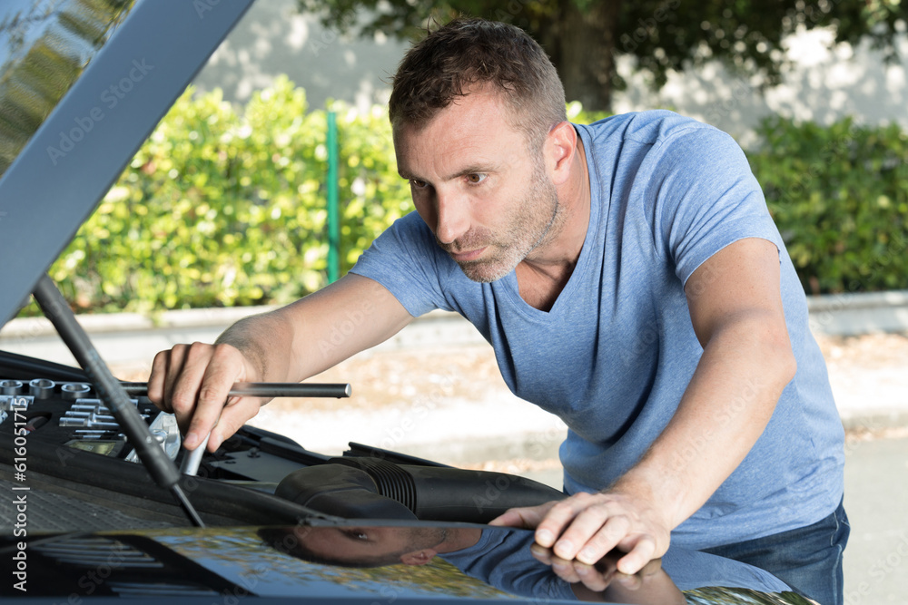 man checking engine of breakdown car Stock Photo | Adobe Stock