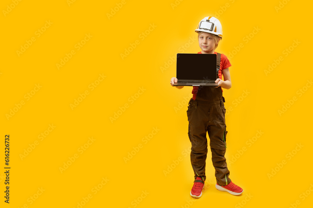 Full-leight portrait of schoolboy in work clothes and protective helmet ...