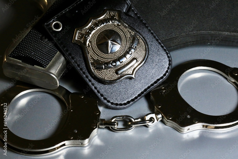 Police badge, handcuffs, and gun Stock Photo | Adobe Stock