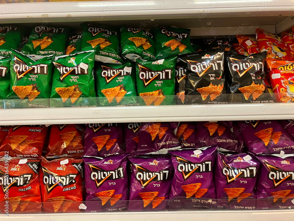 Display with snacks in a store. Translation: Bissli, chips, bamba ...