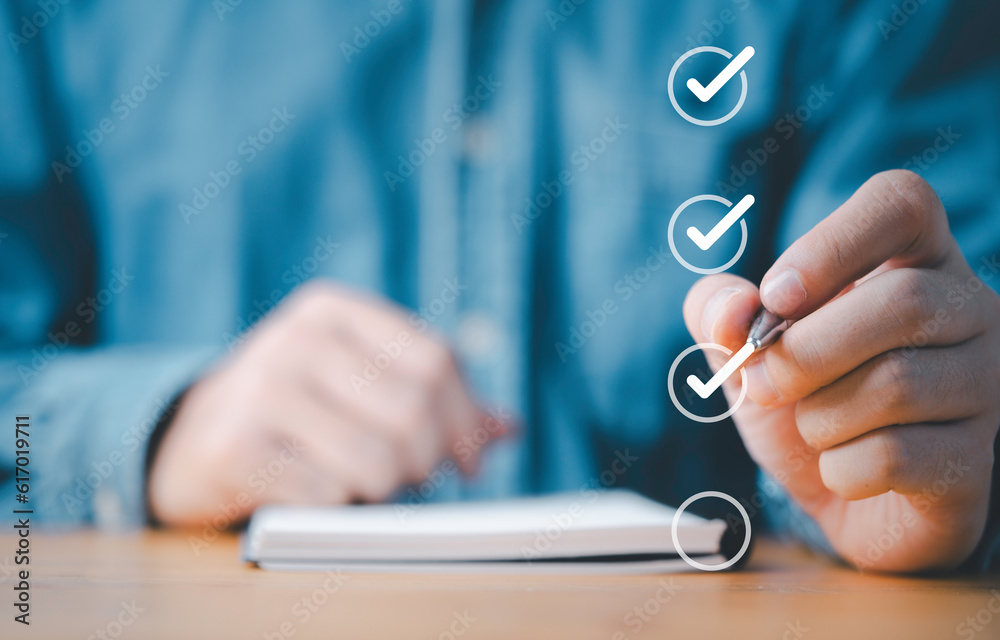 Businessman use pen to tick correct sign mark in checkbox for quality ...