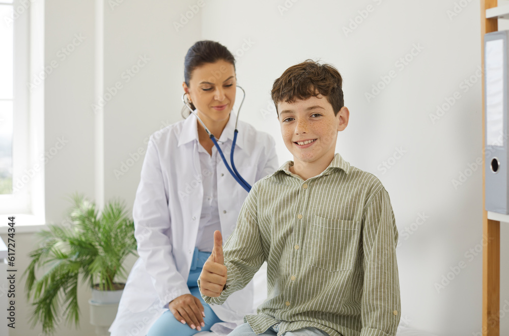 Freindly female pediatrician doing medical checkup of cute boy. Smiling ...