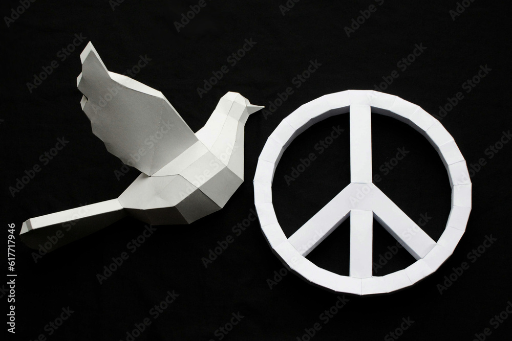 Paper Peace sign and paper dove on a black background, a symbol of ...