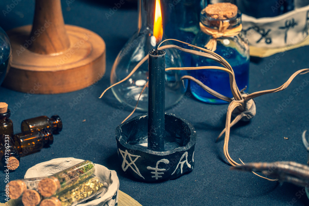 Witchcraft altar selective focus to details of candles light and magic ...