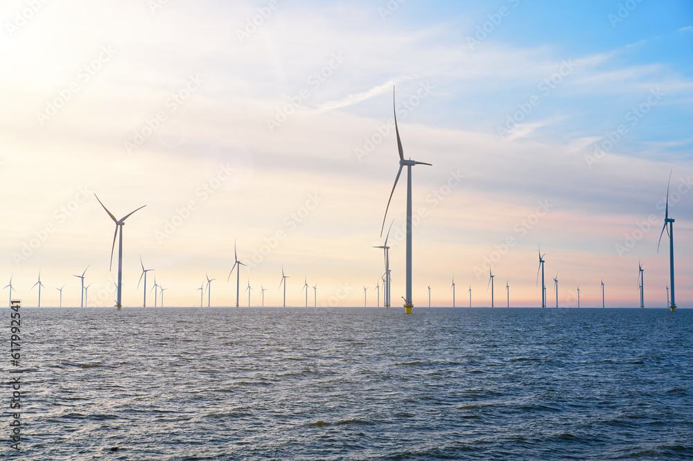 Offshore Windmill farm. windmills isolated at sea on a beautiful bright ...