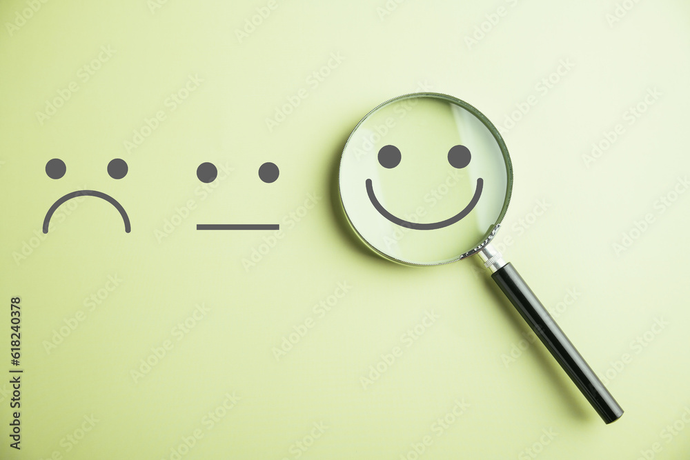 Magnifying glass reveals smiley face, finding happiness amid sadness ...