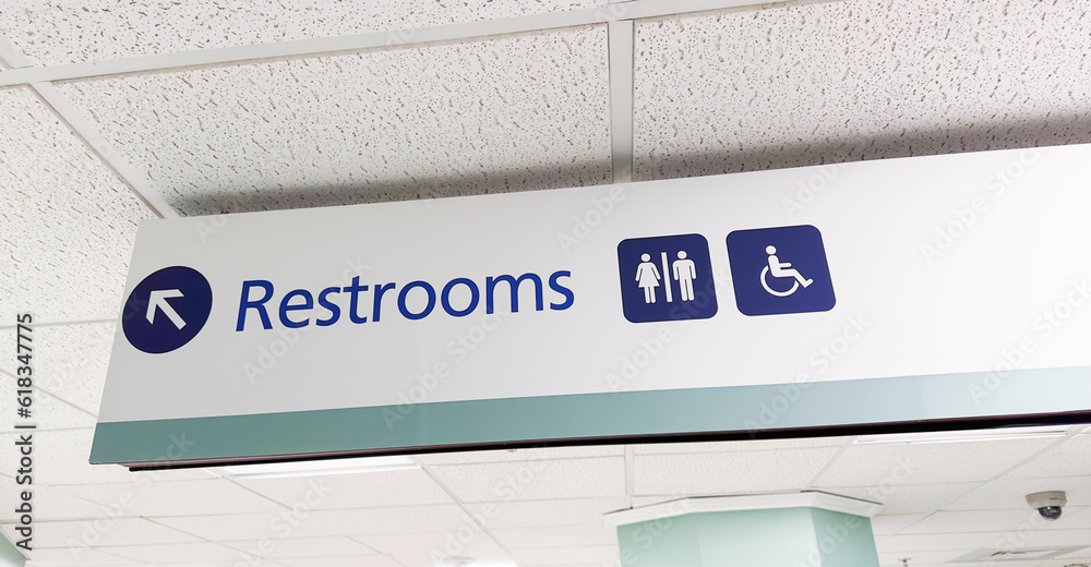 restroom sign depicting gender icons of a woman and a man, symbolizing ...