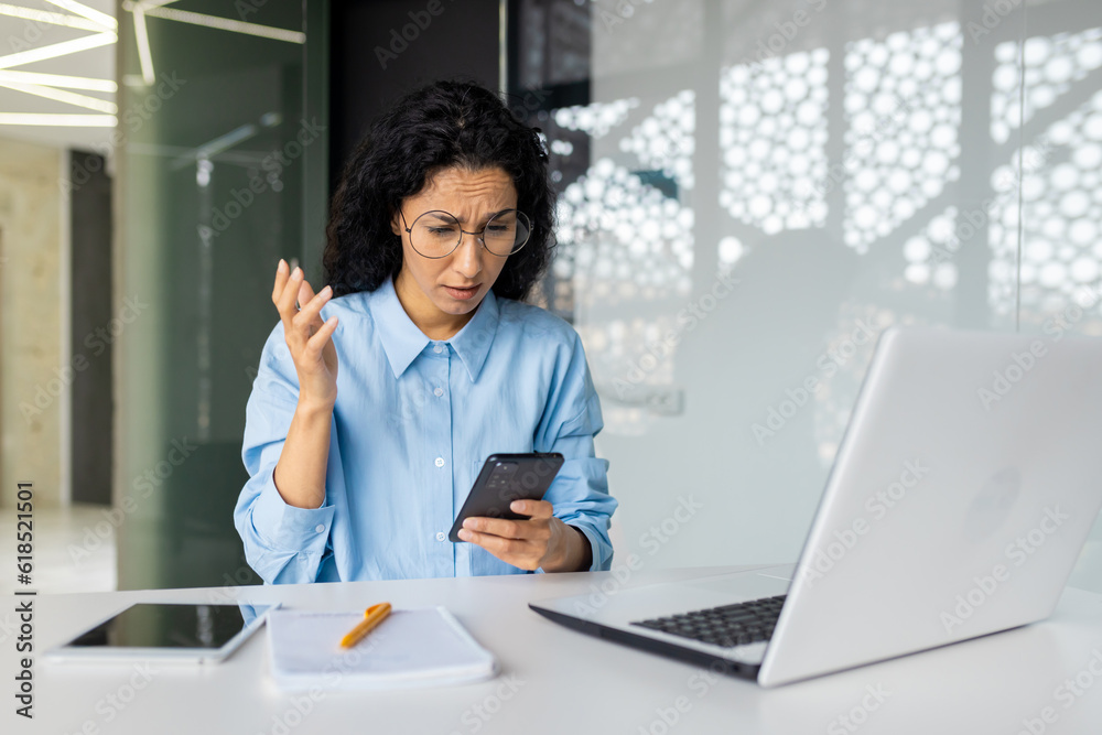 Shocked and upset business woman working inside office at workplace ...