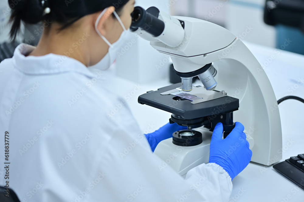 Medical Science Laboratory: Portrait of a scientist looking under a ...