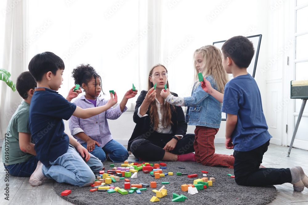 Group of primary school children study and play together in classroom ...