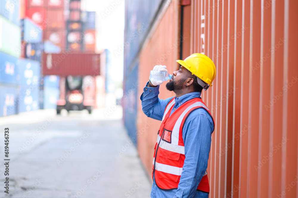 African American man logistic staff workers wearing reflective vests and white helmets in ...
