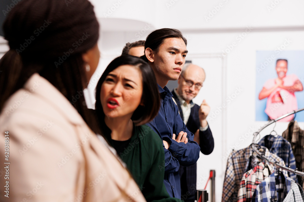 Angry rude diverse shoppers arguing while waiting in line at fashion ...