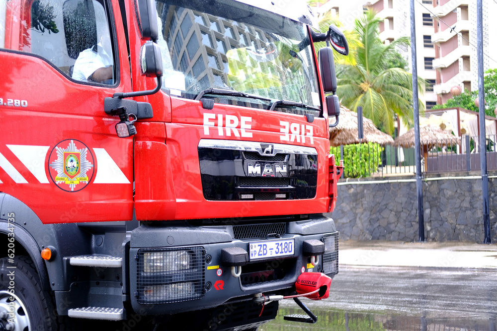 fire department's big red fire truck, emergency van on city street ...