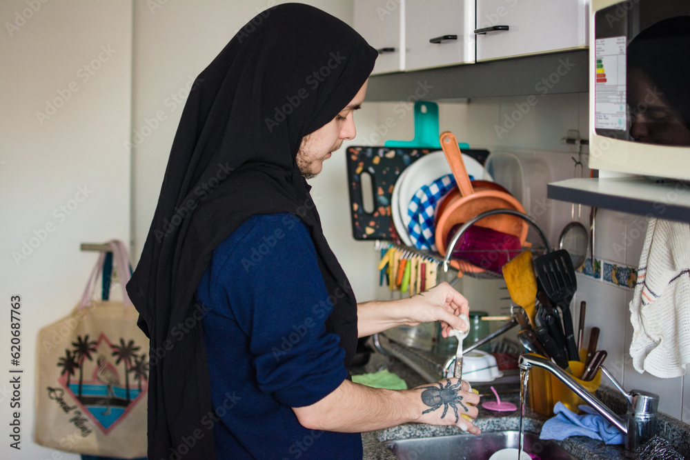 Muslim person doing the dishes Stock Photo | Adobe Stock