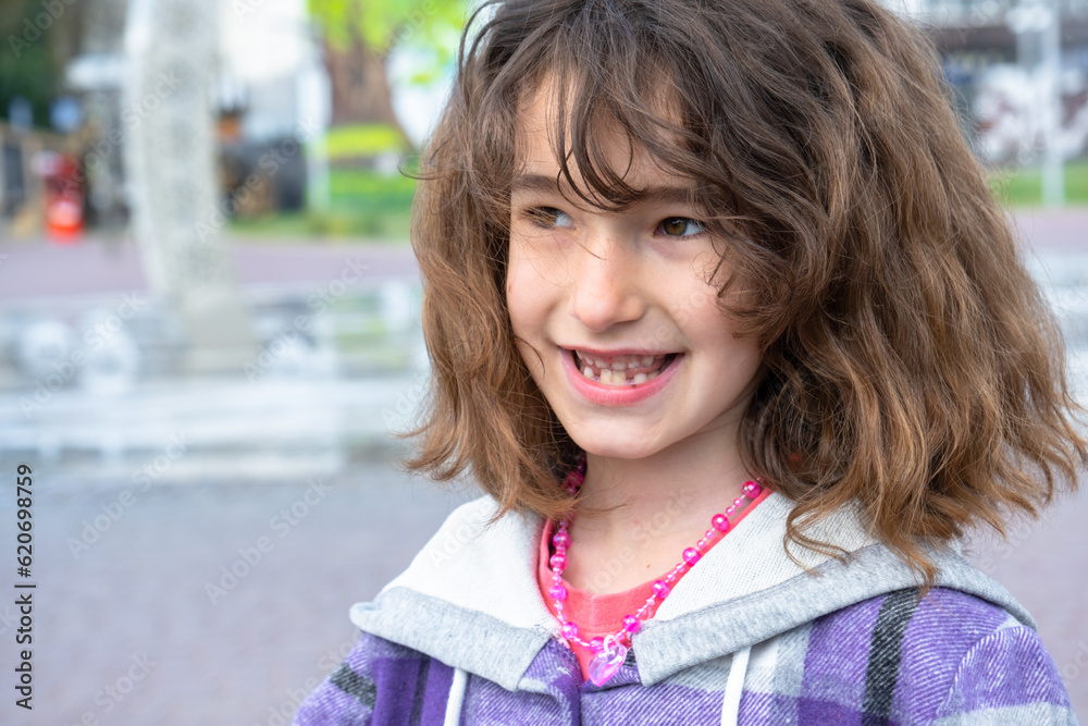 Toothless happy smile of a girl with a fallen lower milk tooth close-up ...
