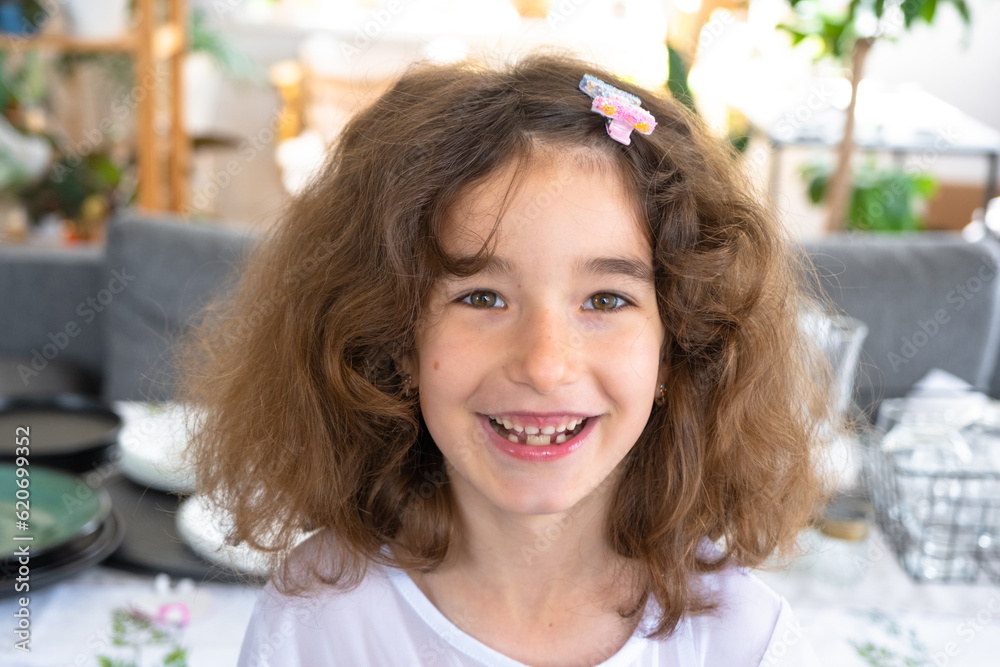 Toothless happy smile of a girl with a fallen lower milk tooth close-up ...