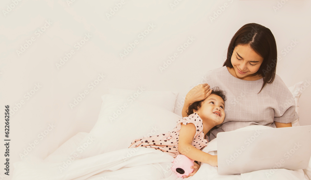 Asian mother caring for her daughter to lull sleep on the bed this ...