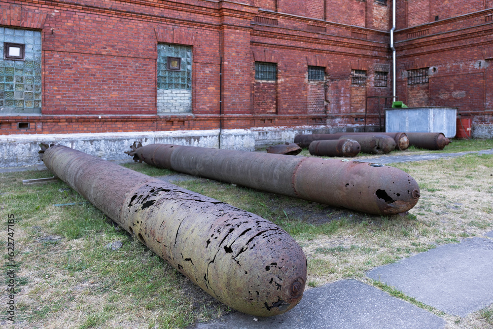 Old derelict torpedoes or bombs lie in front of the Karosta Prison ...