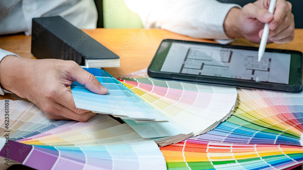 Designer hand choosing and pointing at color swatch or rainbow colour ...