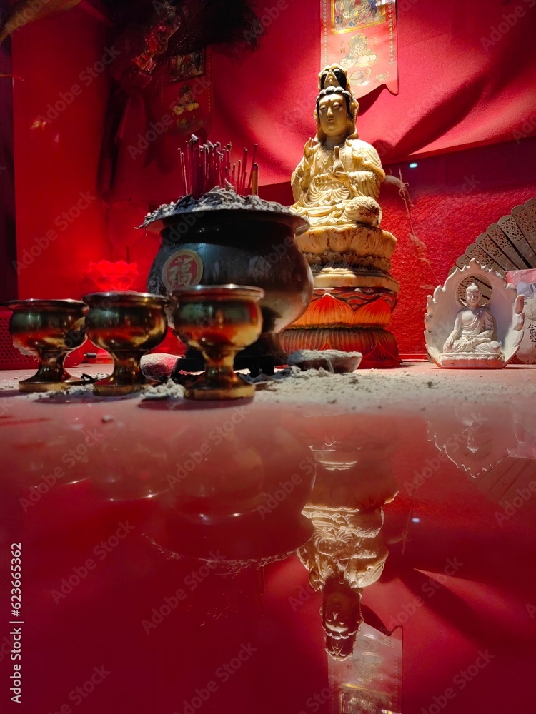 Statue of the goddess of compassion also called "Quan Yin" with shades ...