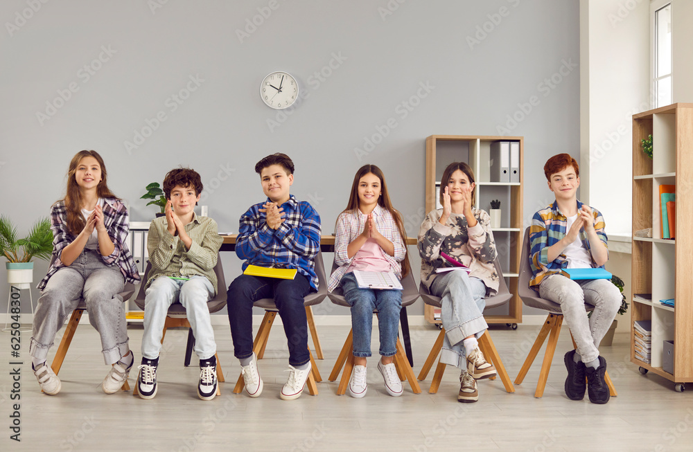 Student audience clapping hands in class. Group of happy school ...